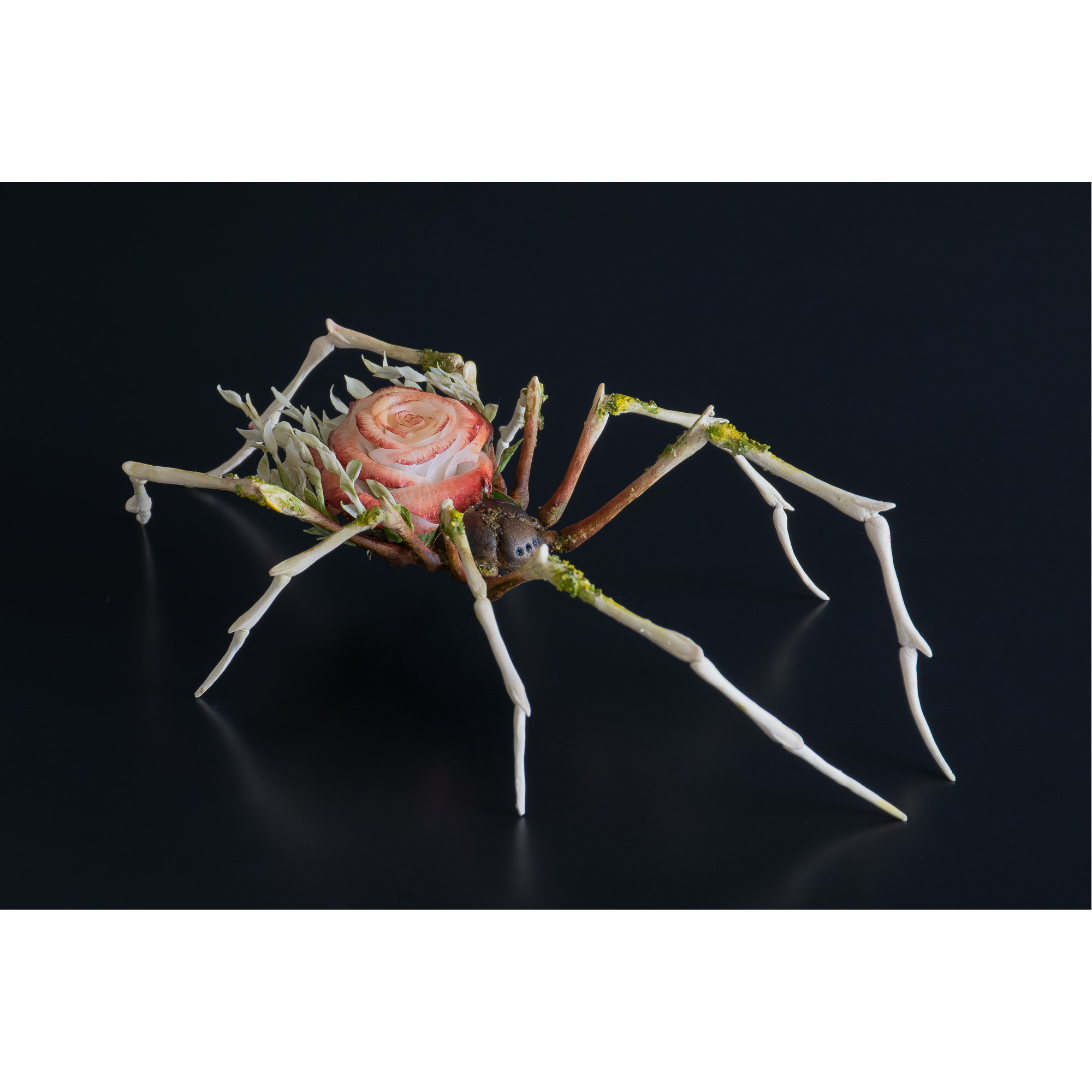 Collectible Handmade spider sculpture with a rose made of air clay.