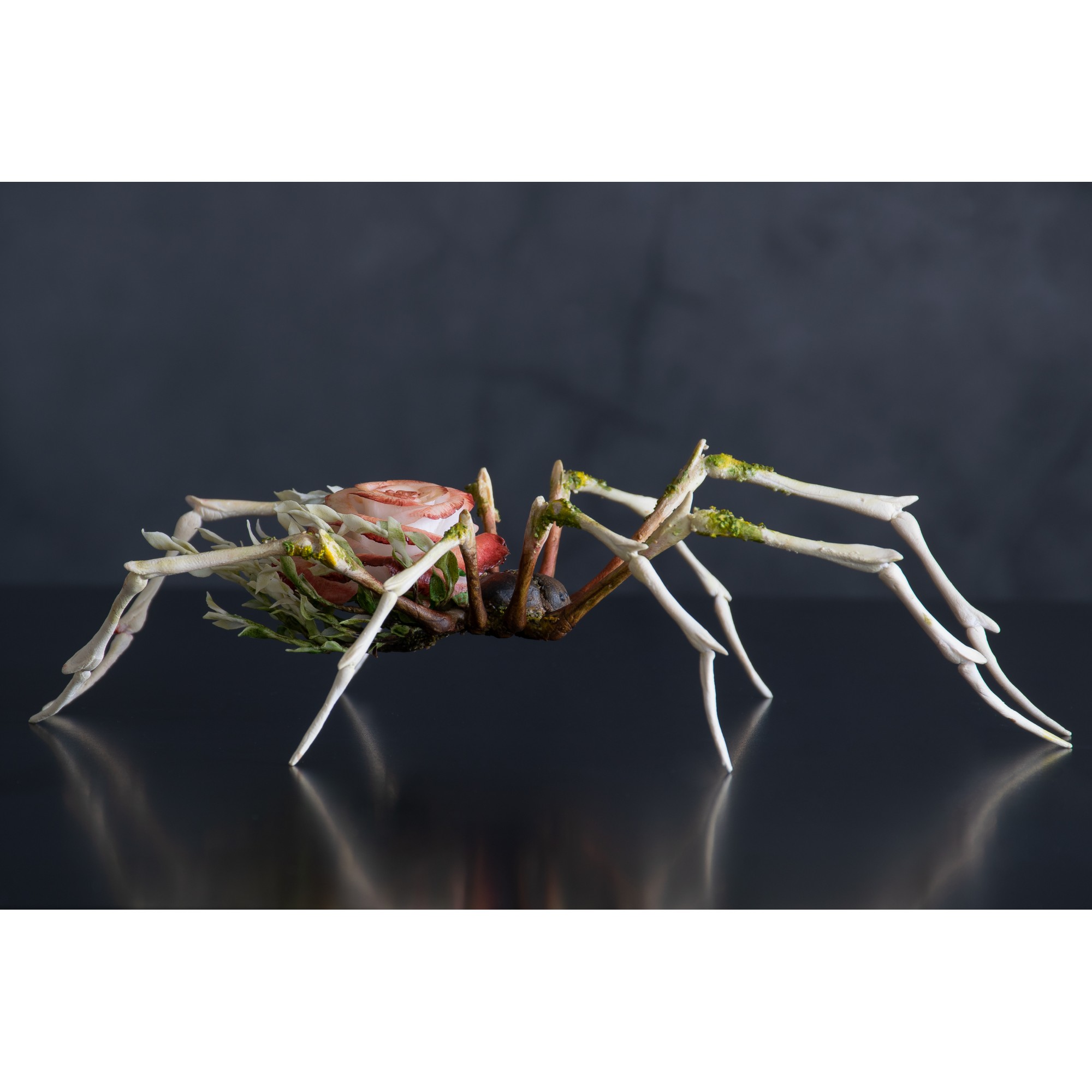 Collectible Handmade spider sculpture with a rose made of air clay.