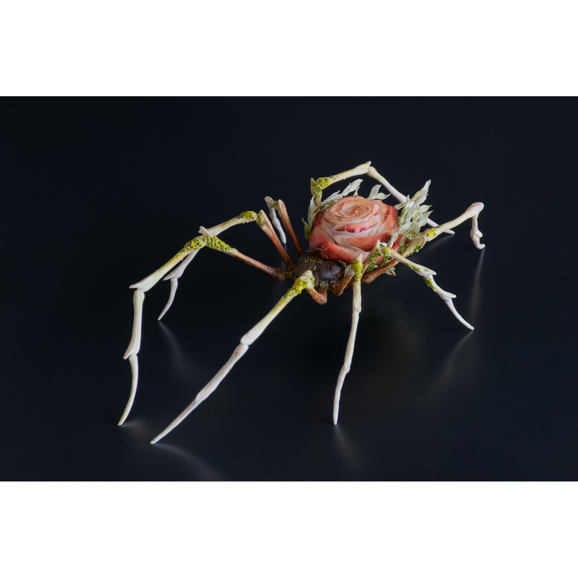 Collectible Handmade spider sculpture with a rose made of air clay.