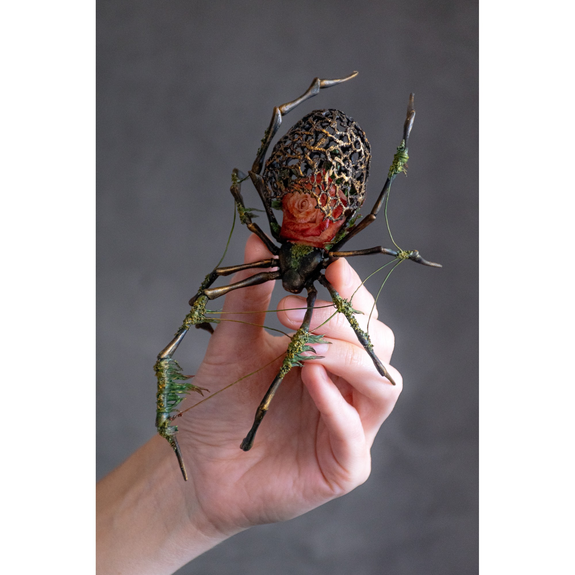 Collectible Handmade black spider sculpture with a rose
